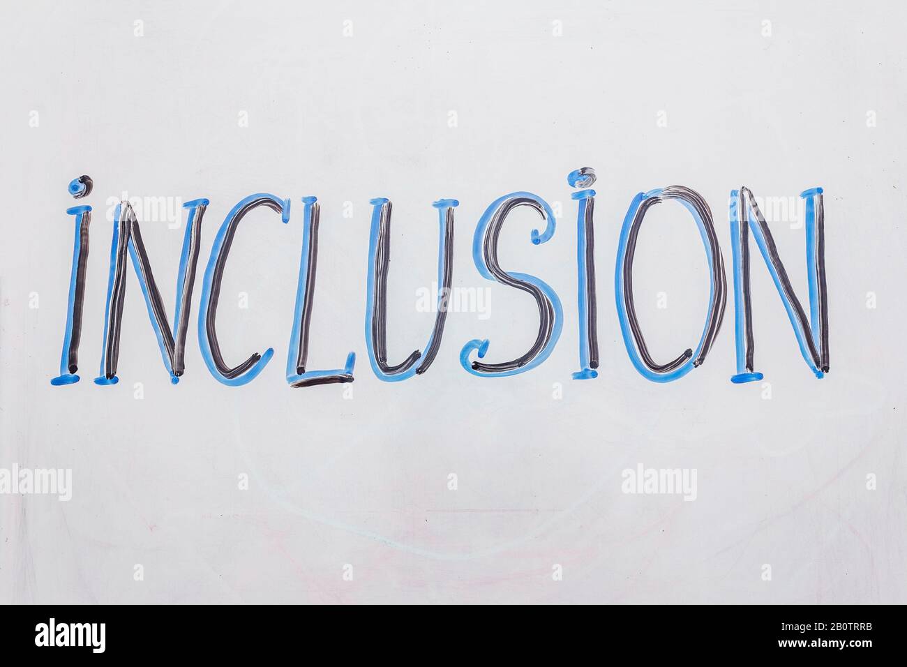 Hand drawn word "inclusion" on marker board. Blue and black color ...