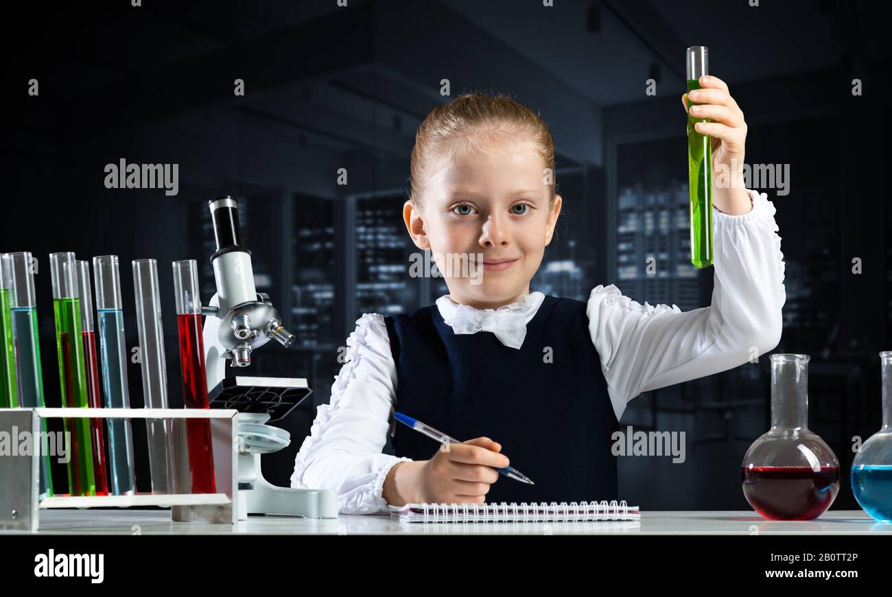 Little girl scientist examining test tube Stock Photo - Alamy