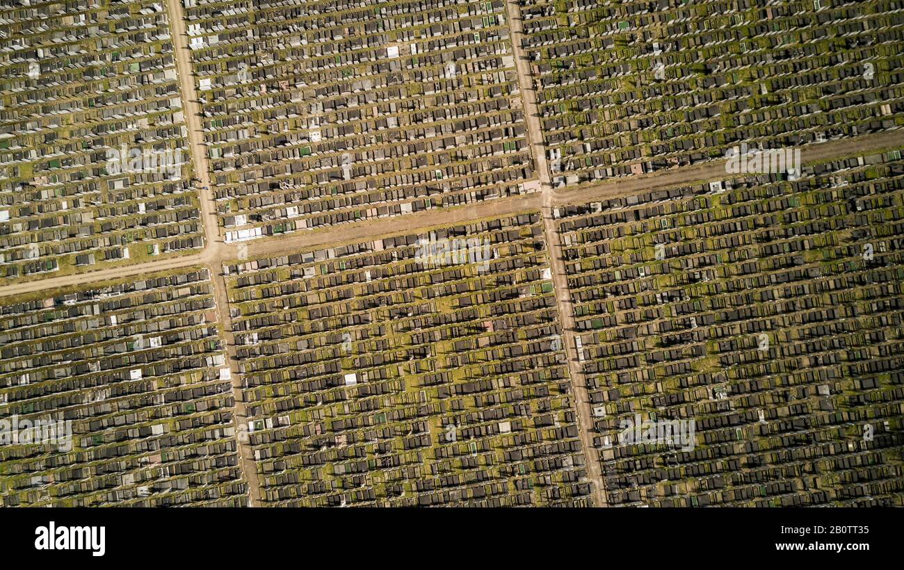 Gravestones and cemetery. Vertical aerial drone view looking down onto ...