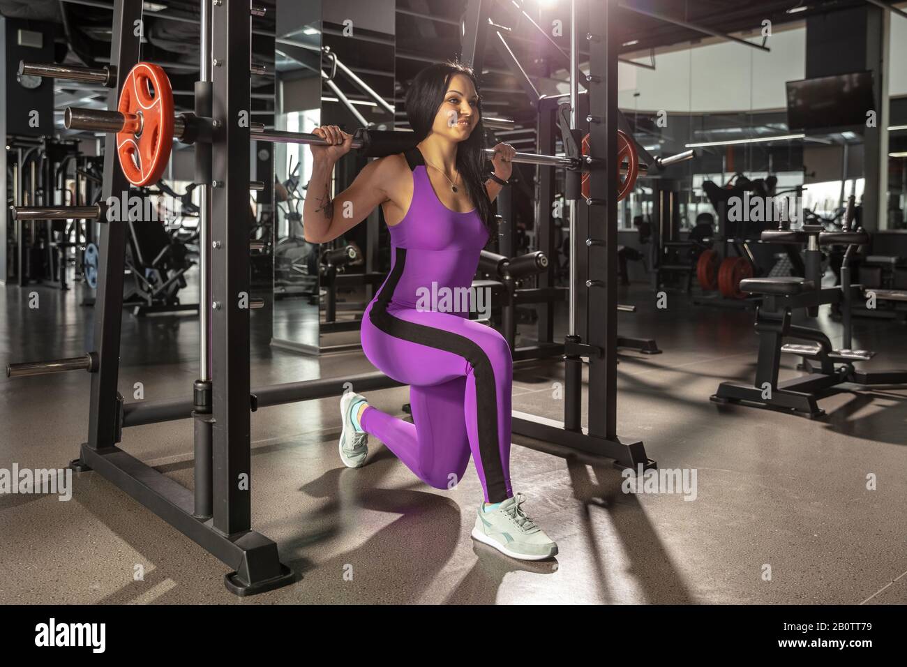 Strong. Young muscular caucasian woman practicing in gym with equipment ...