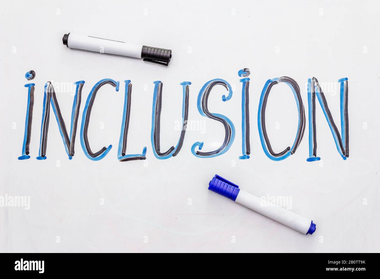 Hand drawn word "inclusion" on marker board. Blue and black color ...