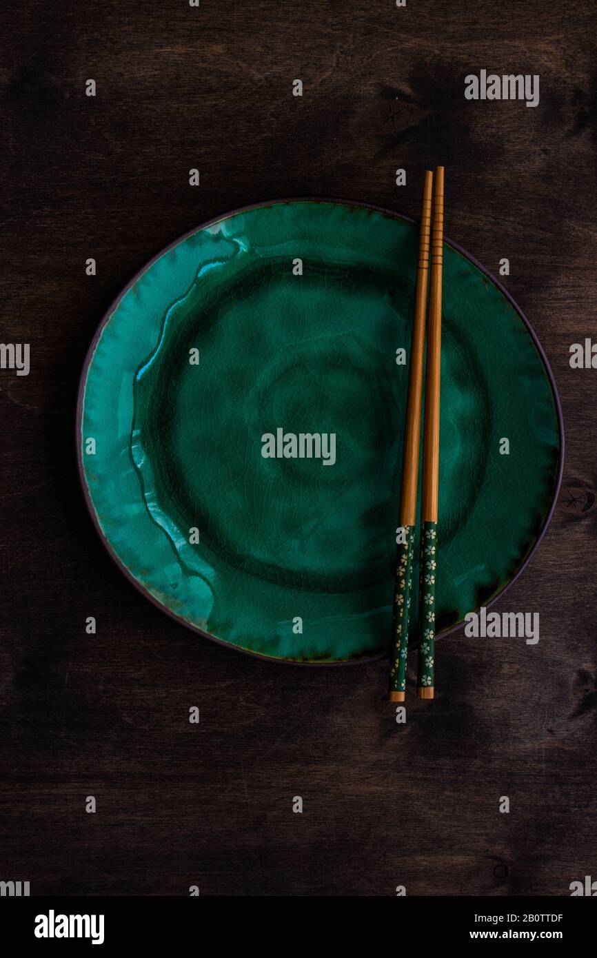 Asian style table setting with cherry blossom and wooden chopsticks ...