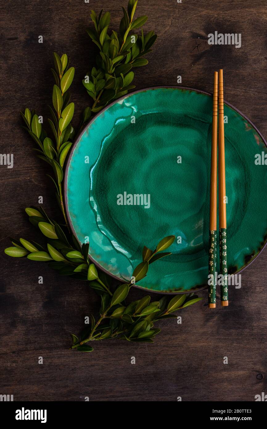 Asian style table setting with cherry blossom and wooden chopsticks ...