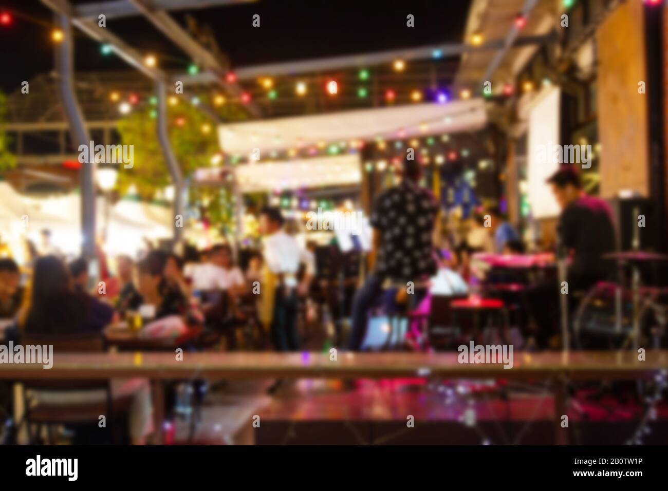 blurred image Lots of people enjoy at the bar pub fun of night festival ...