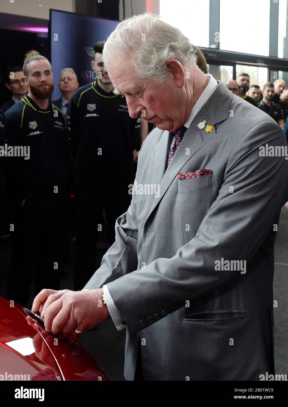 The Prince of Wales places a logo on the new Aston Martin DBX at the ...