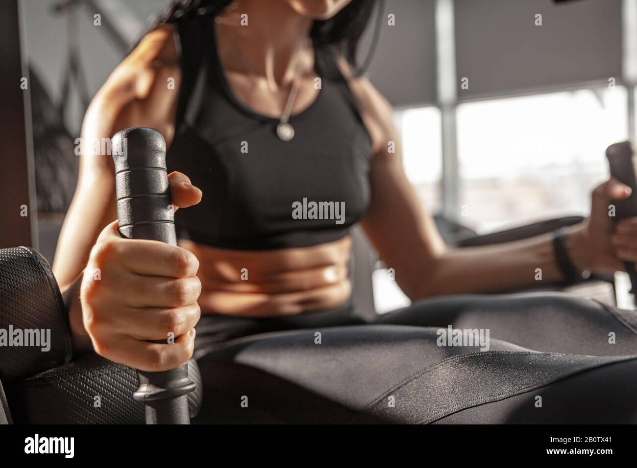 Wellness. Young muscular caucasian woman practicing in gym with ...