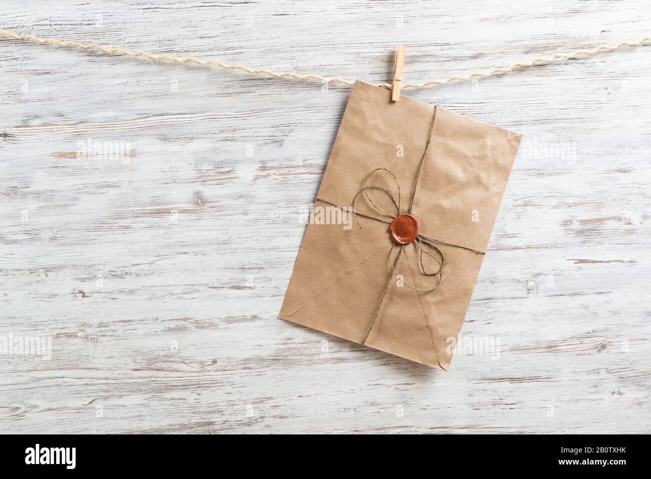 Old paper envelope hanging on rope Stock Photo - Alamy