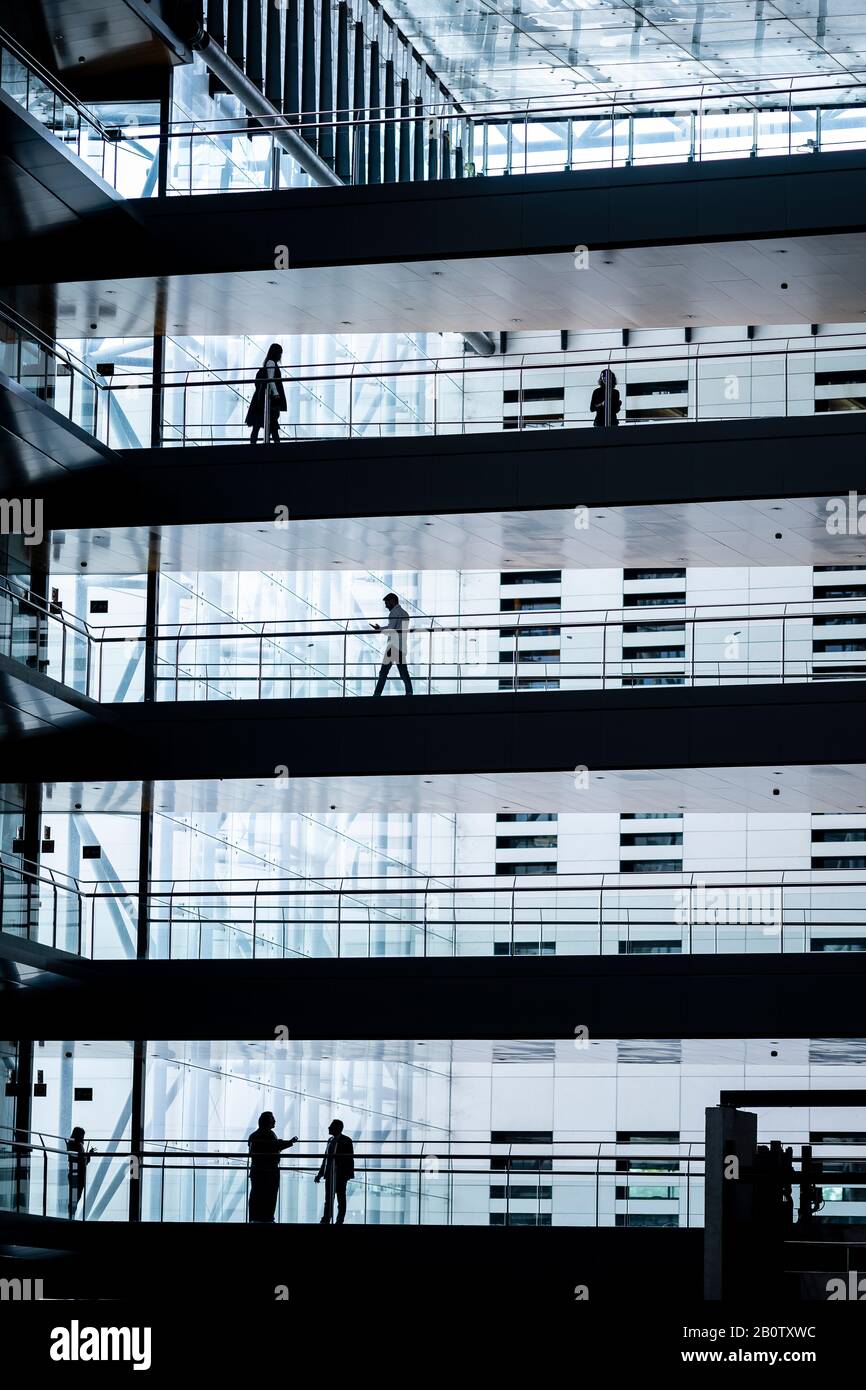 Modern business building with people working on different floors Stock ...