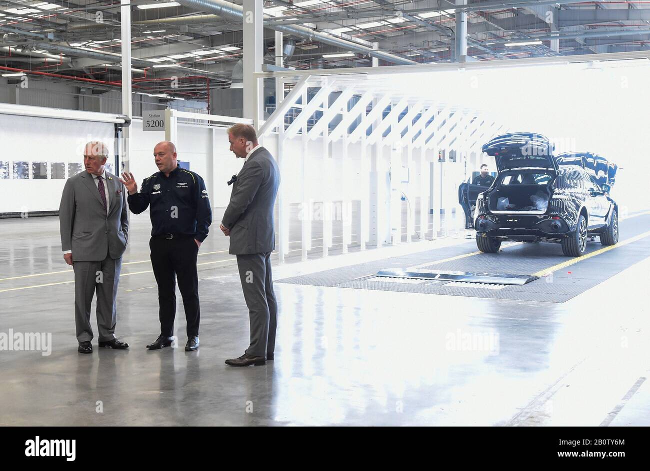 The Prince of Wales (left) speaks with staff during a visit to the new ...