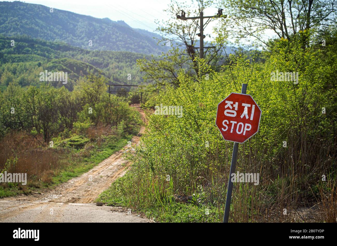 Countryside and stop sign on the South Korea border with North Korea ...