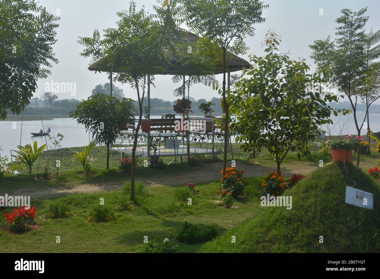 A beautiful Garden with trees, flowers and green grass growing on a ...