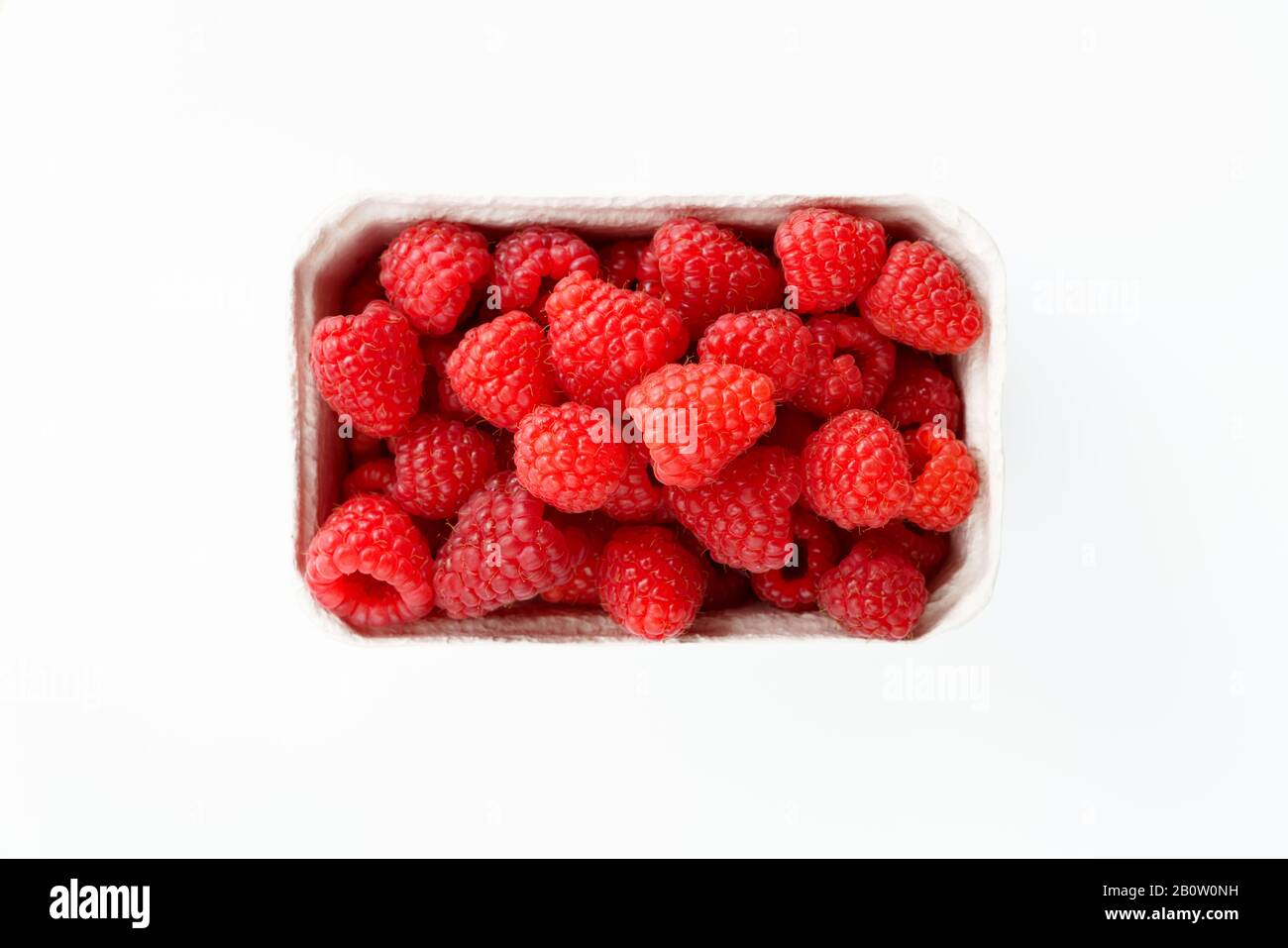 Freshly picked organic raspberries in recycled paper cup. High ...