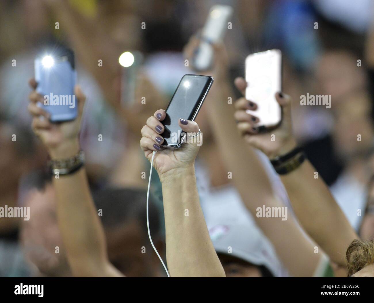 Person holding a cellphone with the flash on and hands up Stock Photo ...