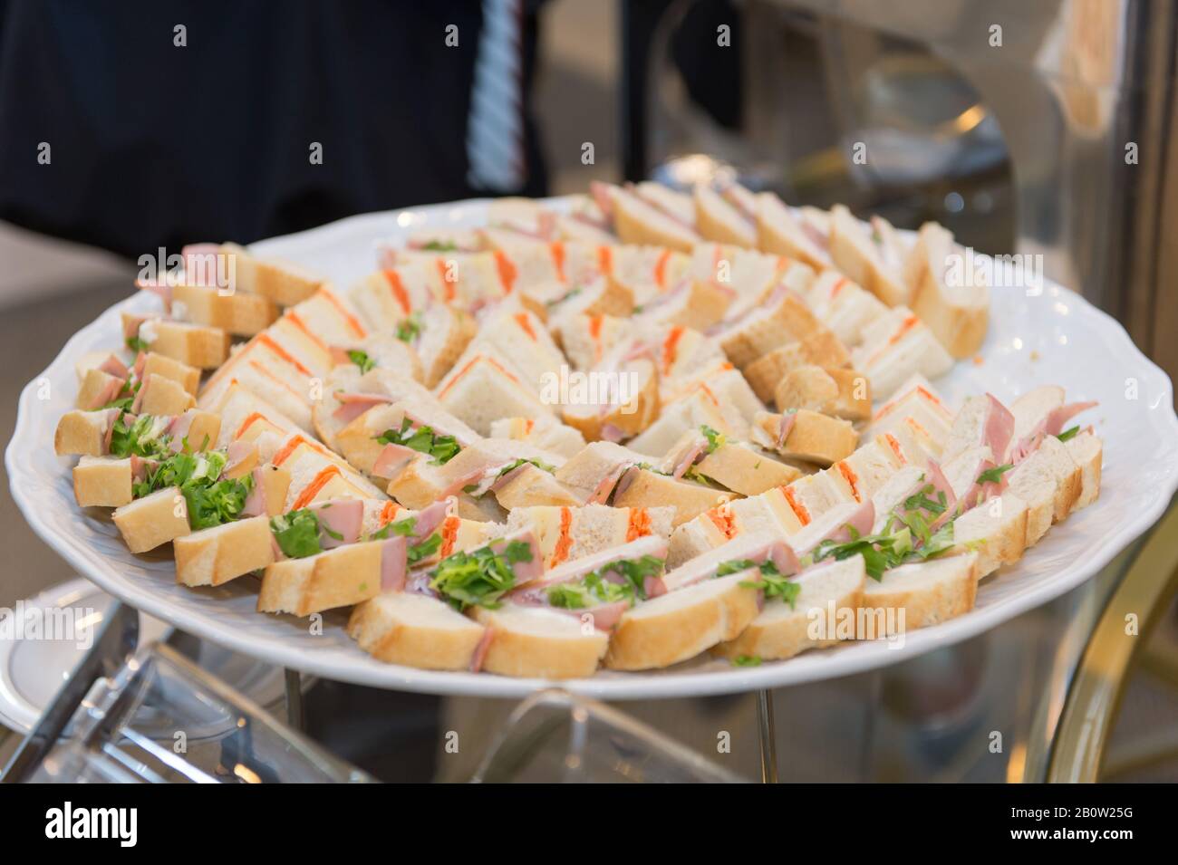 Plate with pieces of sandwiches cut into slices Stock Photo - Alamy