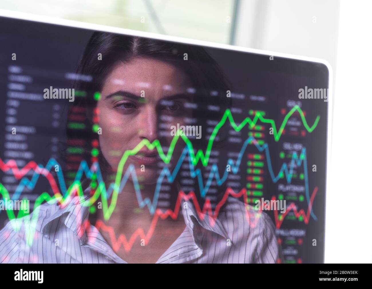 Female analyst viewing financial market data on a screen Stock Photo ...