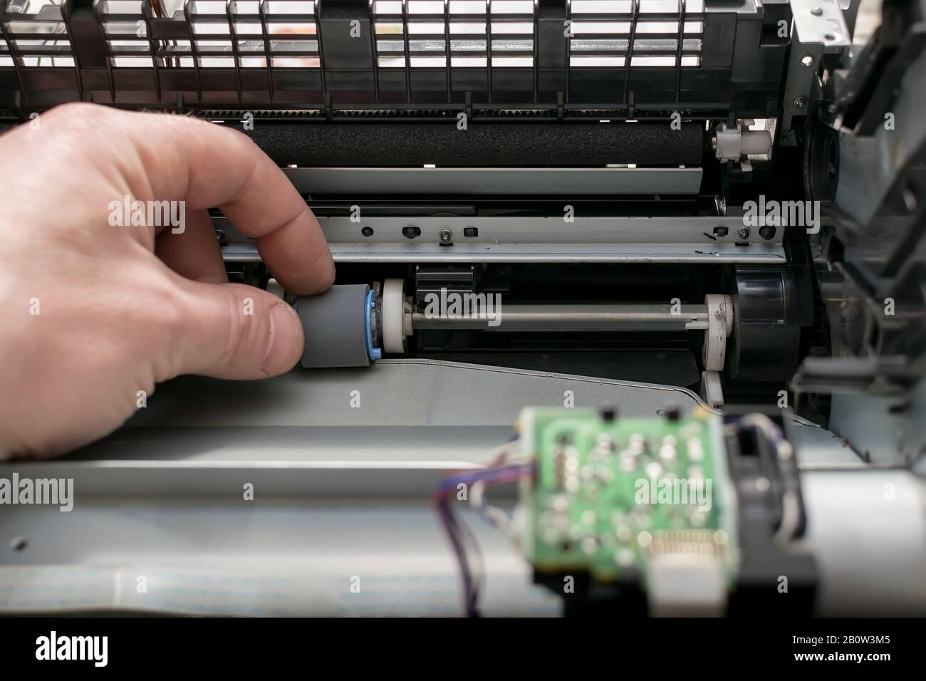 closeup, the hand of the service center master changes the rubber grip ...