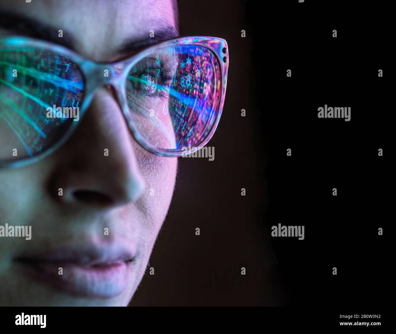 Electronic circuit board on computer monitor reflecting in glasses of a ...