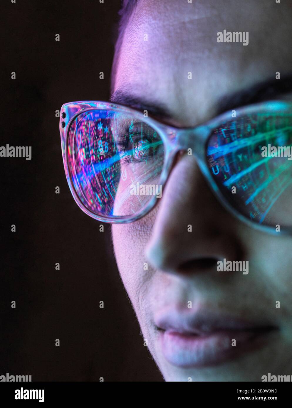 Electronic circuit board on computer monitor reflecting in glasses of a ...