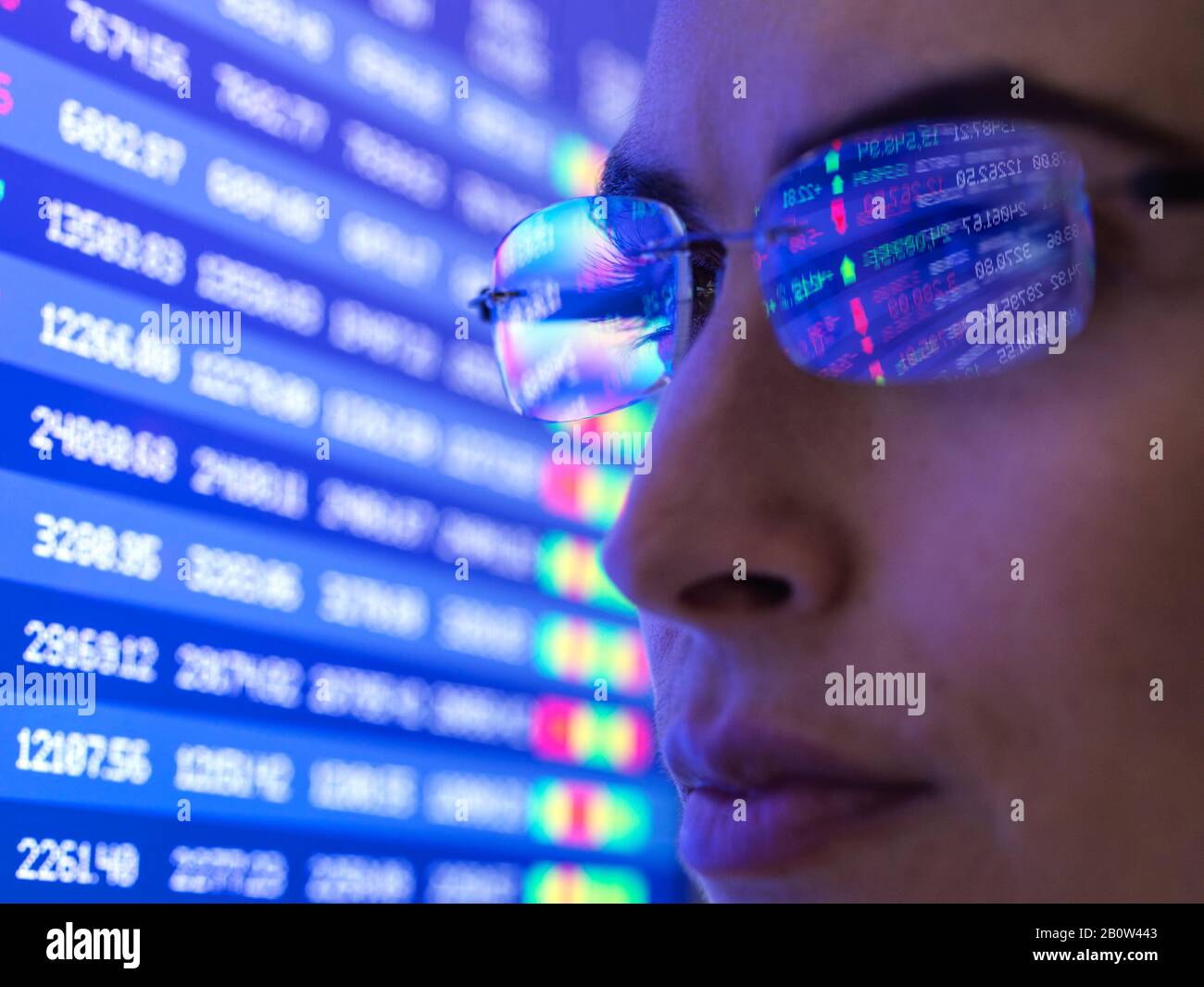 Female analyst viewing financial market data on a screen Stock Photo ...