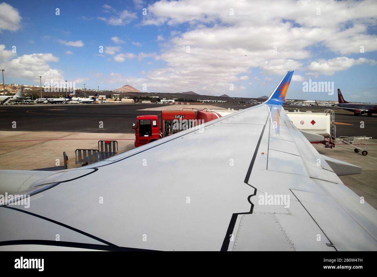 jet2 aircraft wing with plane being refuelled at lanzarote arricife ...