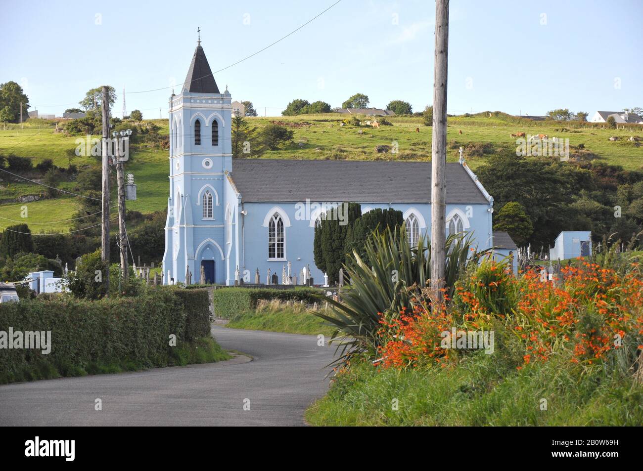Beautiful old 19th-century church with a spire on the bend of a narrow ...