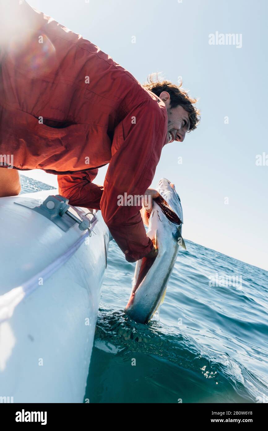 Man pulling boat out water hi-res stock photography and images - Alamy