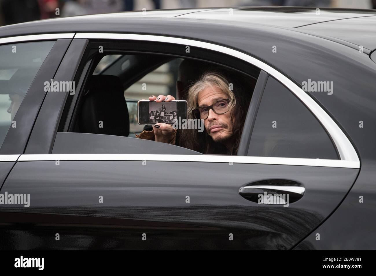 Steve Tyler, singer with the band Aerosmith peers out of a car window ...