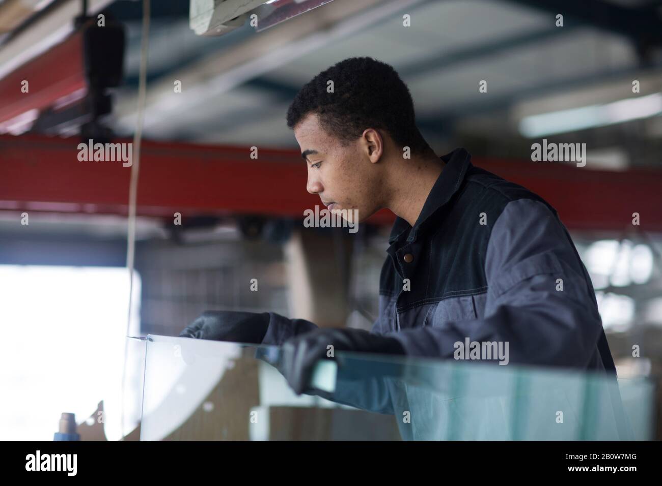 Workman fixing car windshield in workshop Stock Photo - Alamy