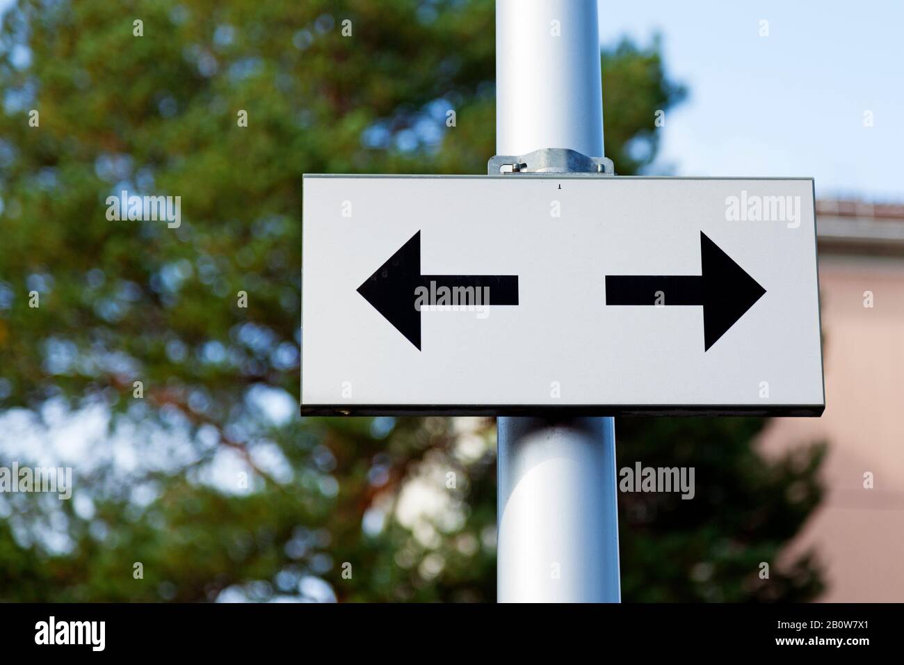 road sign with arrows in two different directions Stock Photo - Alamy