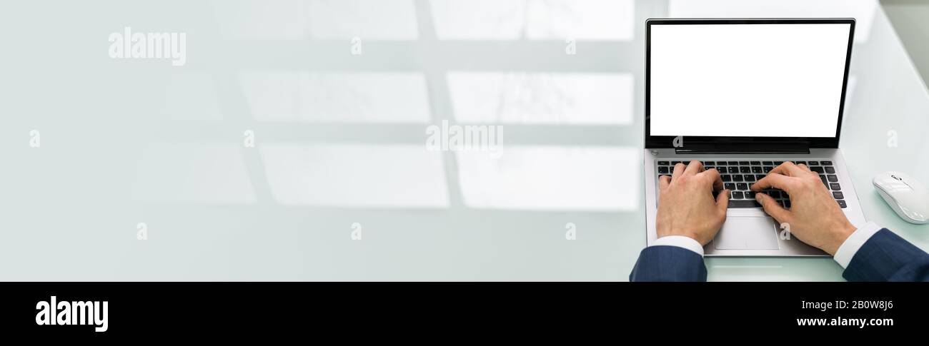 Mid Adult Man Using Laptop At Work Stock Photo - Alamy