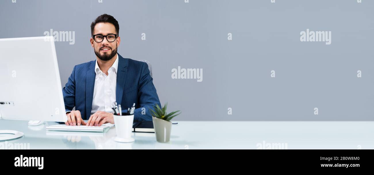 Portrait Of A Businessman At Desk Using Computer Stock Photo - Alamy