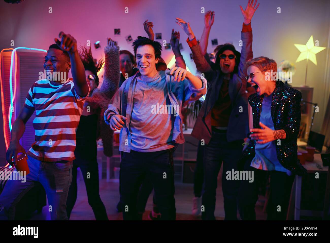 Multiethnic group of young people dancing together and having fun at ...