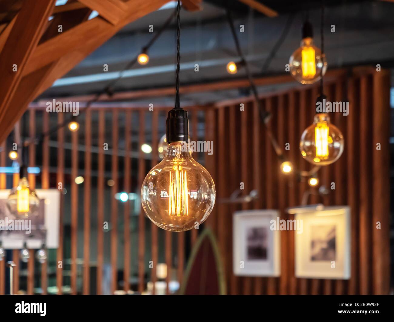 Decorative glowing light bulbs hanging in the interior of the cafe ...