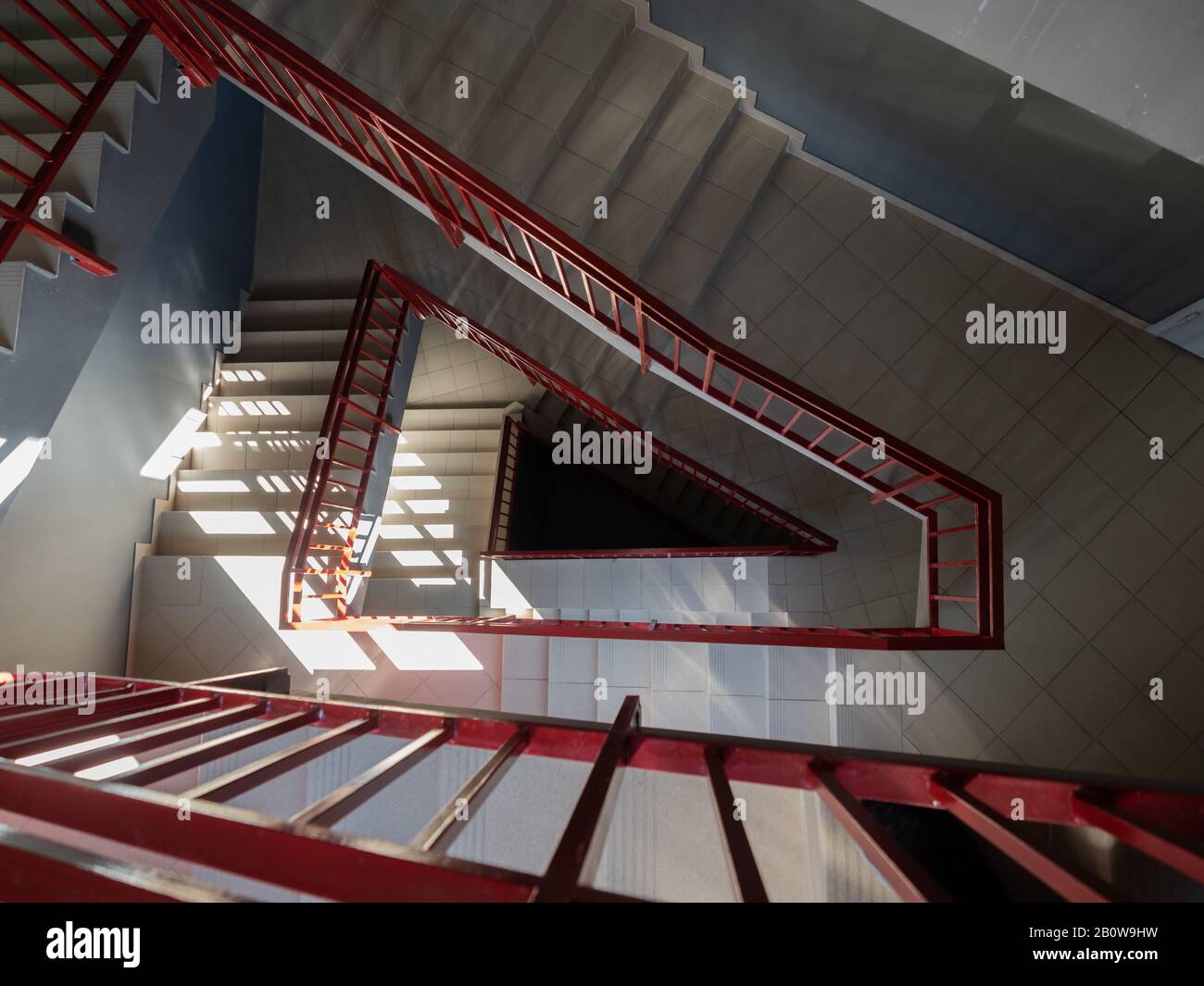 Perspective view of beige staircase in the staircase with red railing ...
