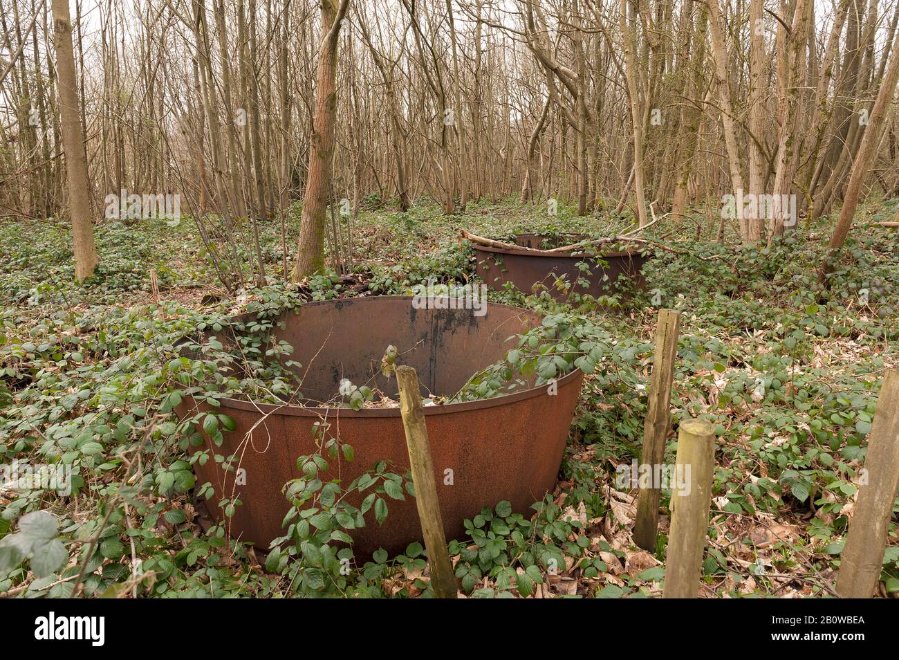 Discarded and rusting 8' steel woodland wood kiln for making charcoal ...