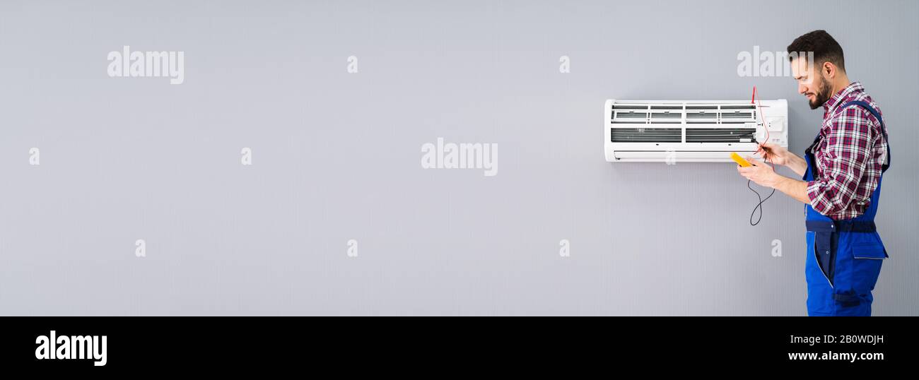 Portrait Of A Mid-adult Male Technician Testing Air Conditioner With ...