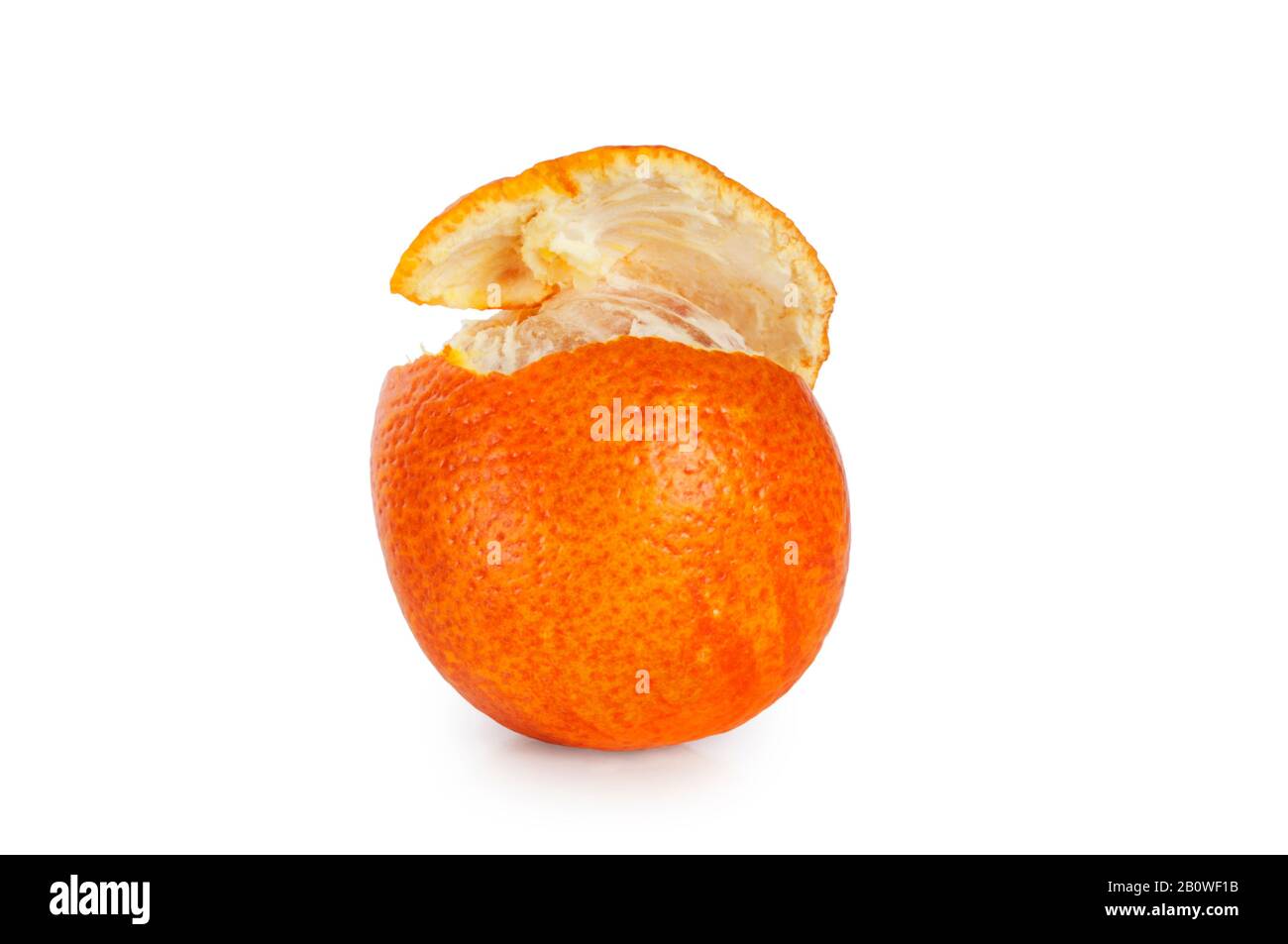 Studio shot of an orange in the process of being peeled cut out against ...