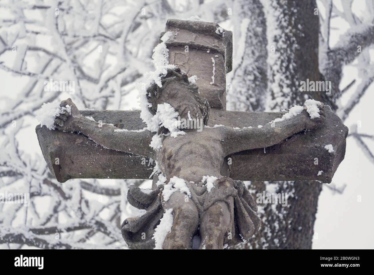 Beautiful Jesus Christ crucifix statue cover with snow, tree in ...