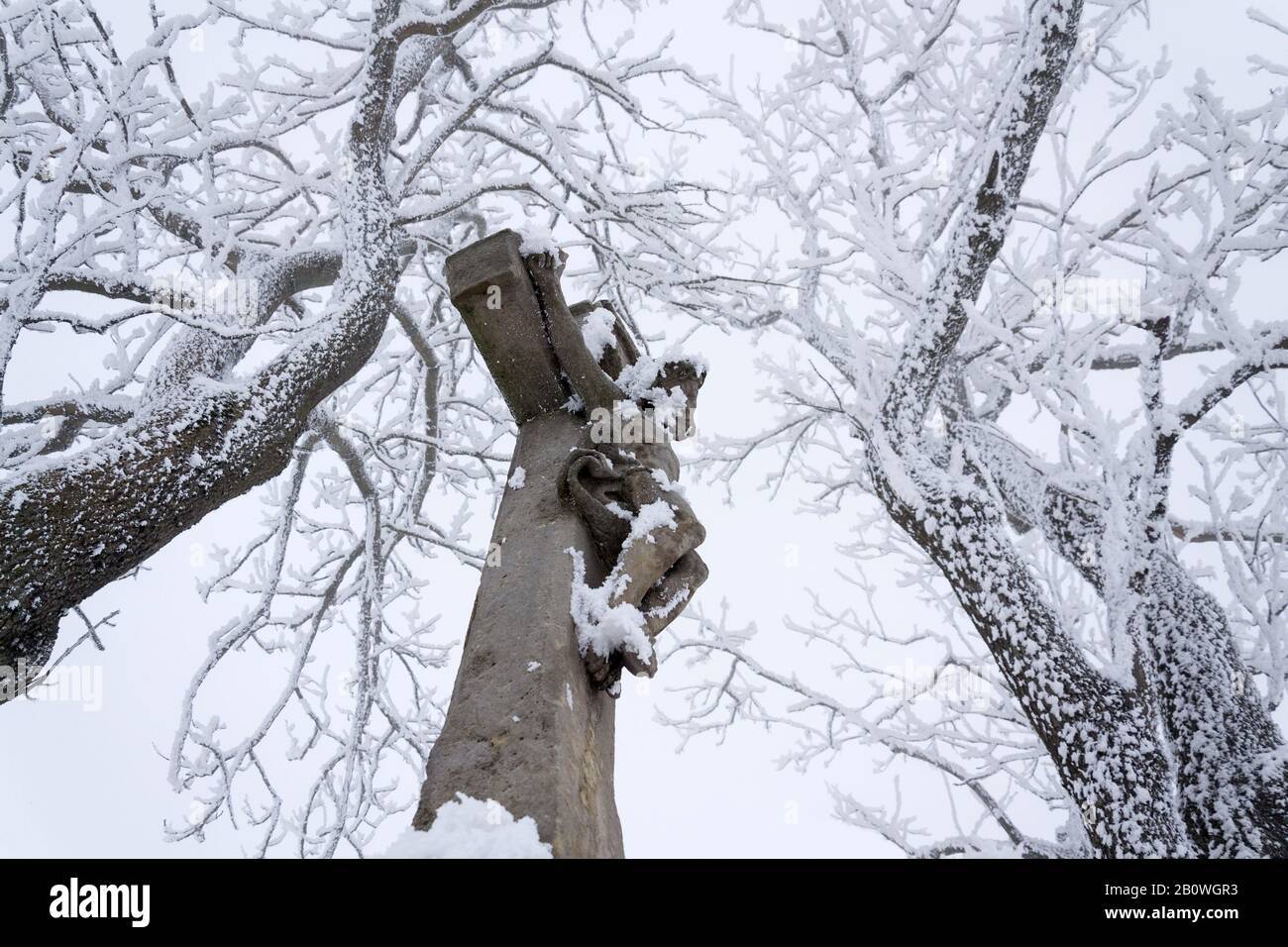Beautiful Jesus Christ crucifix statue cover with snow, tree in ...