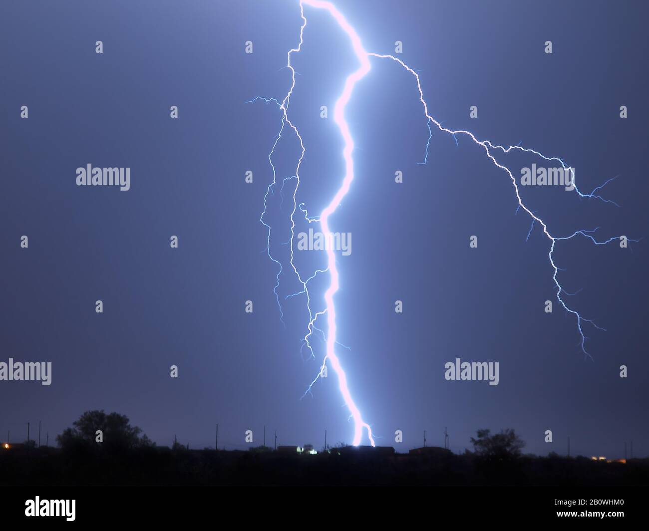 A massive lightning bolt striking behind a home in Arlington Arizona ...
