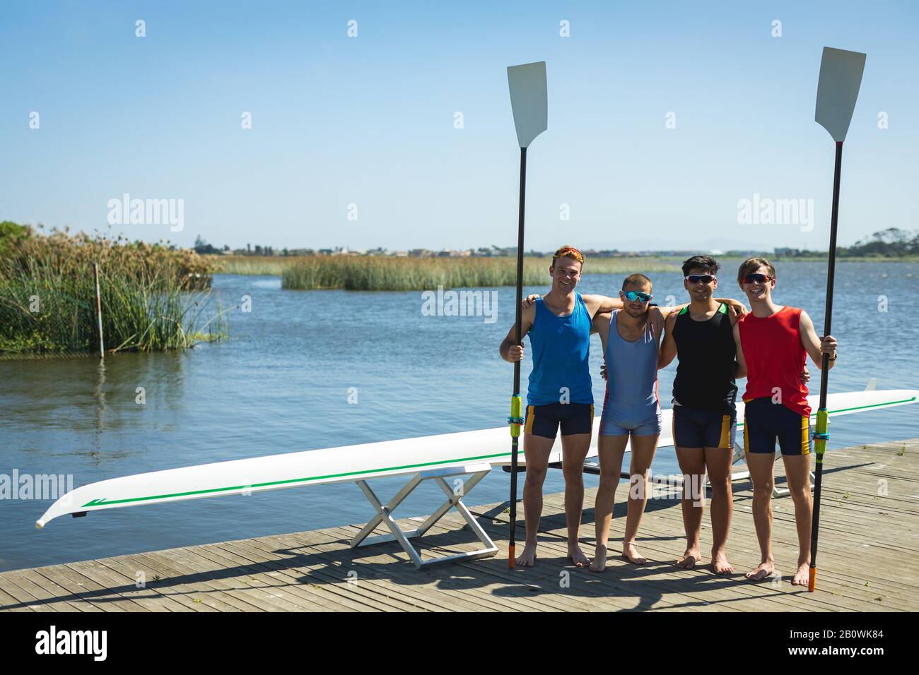 Friends posing together before rowing Stock Photo - Alamy