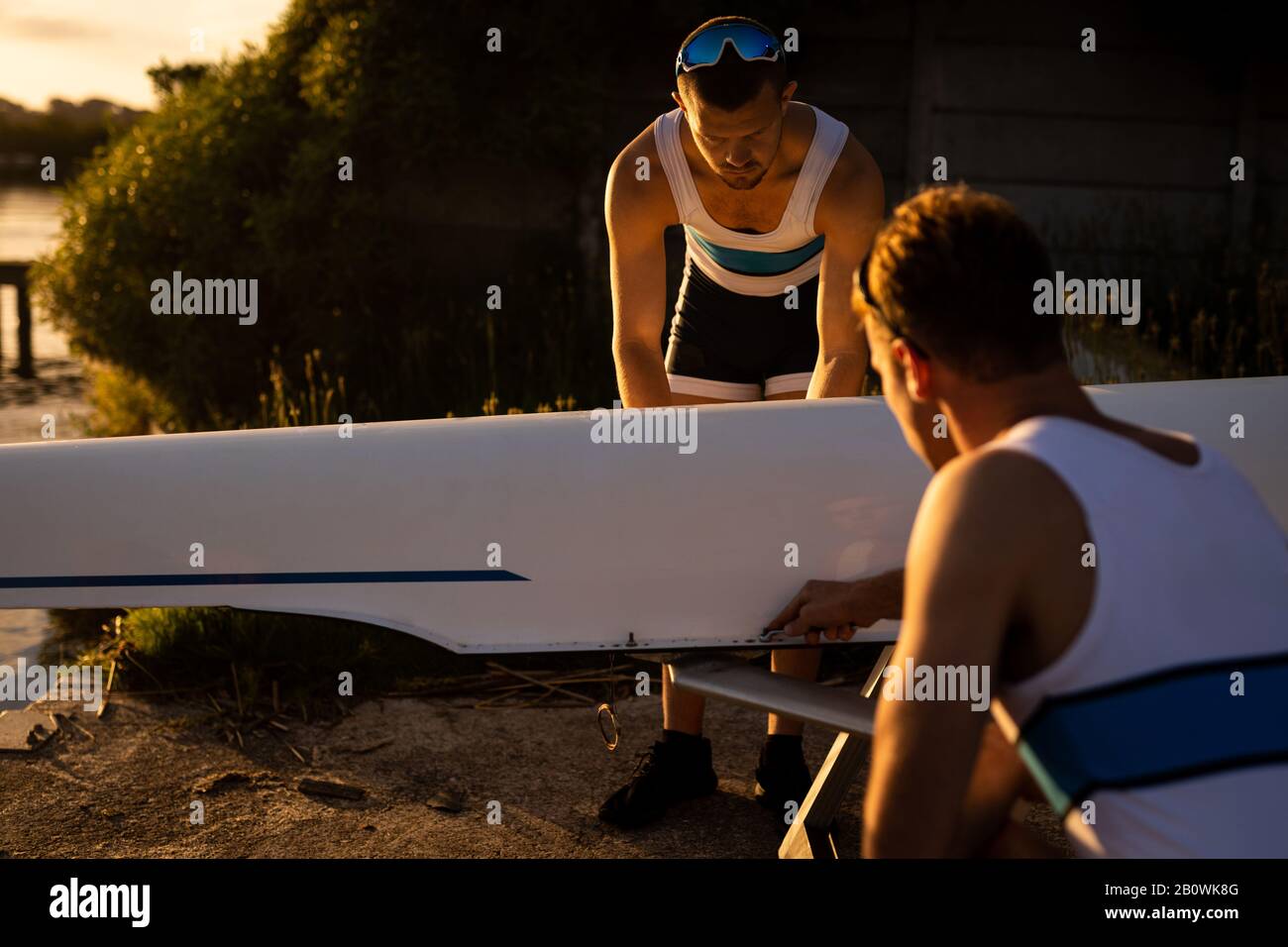 Friends preparing the rowing boat together Stock Photo - Alamy