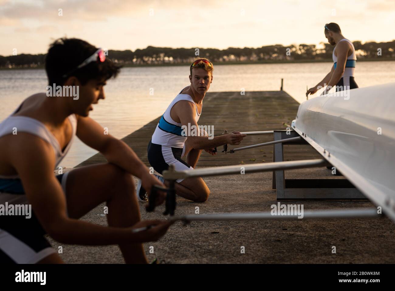 Friends preparing the rowing boat together Stock Photo - Alamy