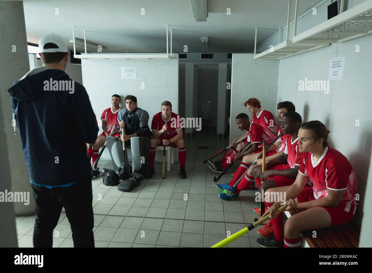 Hockey players sitting in the changing room Stock Photo - Alamy