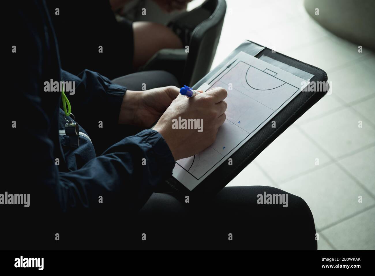 Coach holding a sheet of paper Stock Photo - Alamy