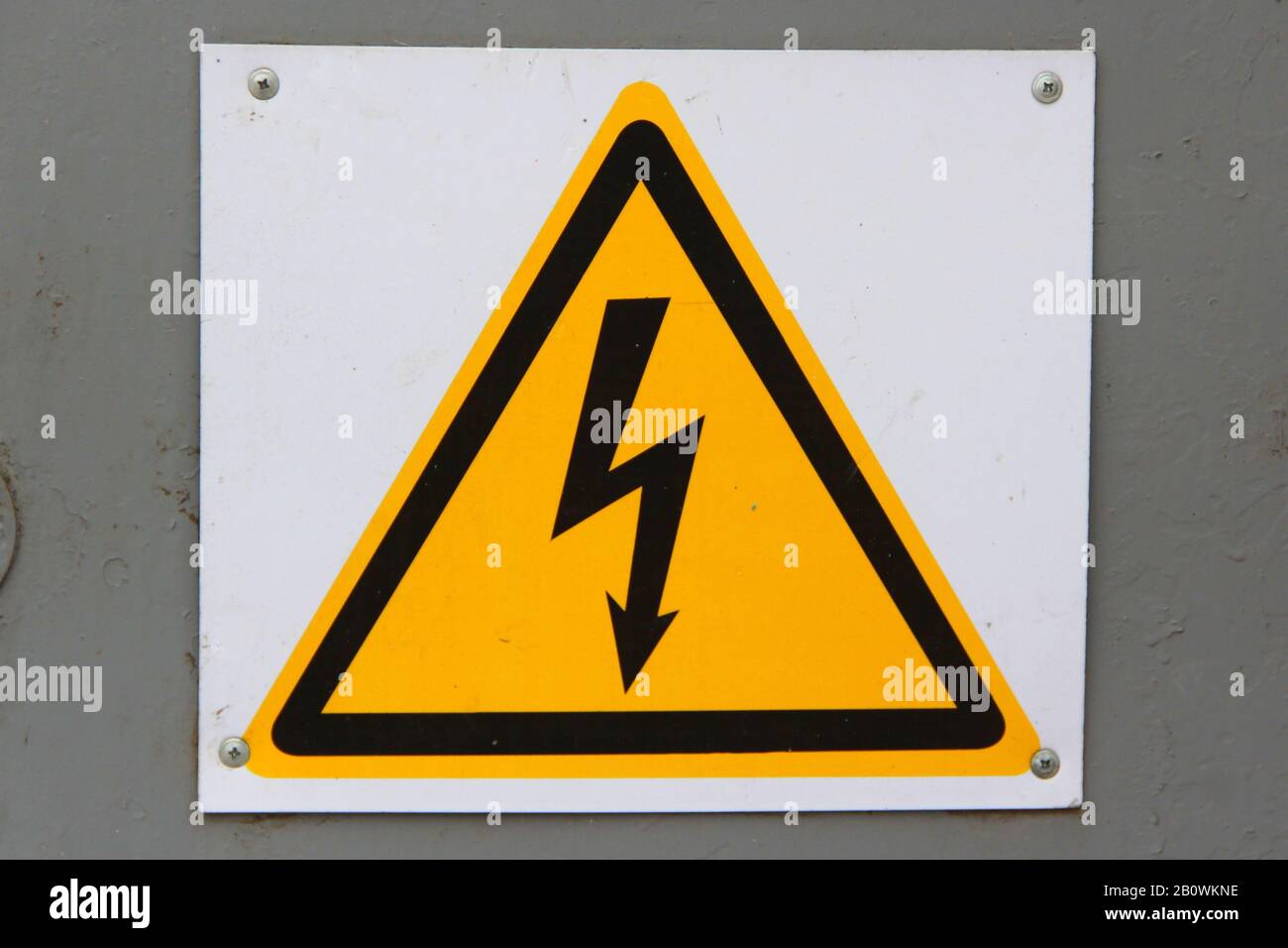 Sign of danger of electric shock on white isolation background. Black ...