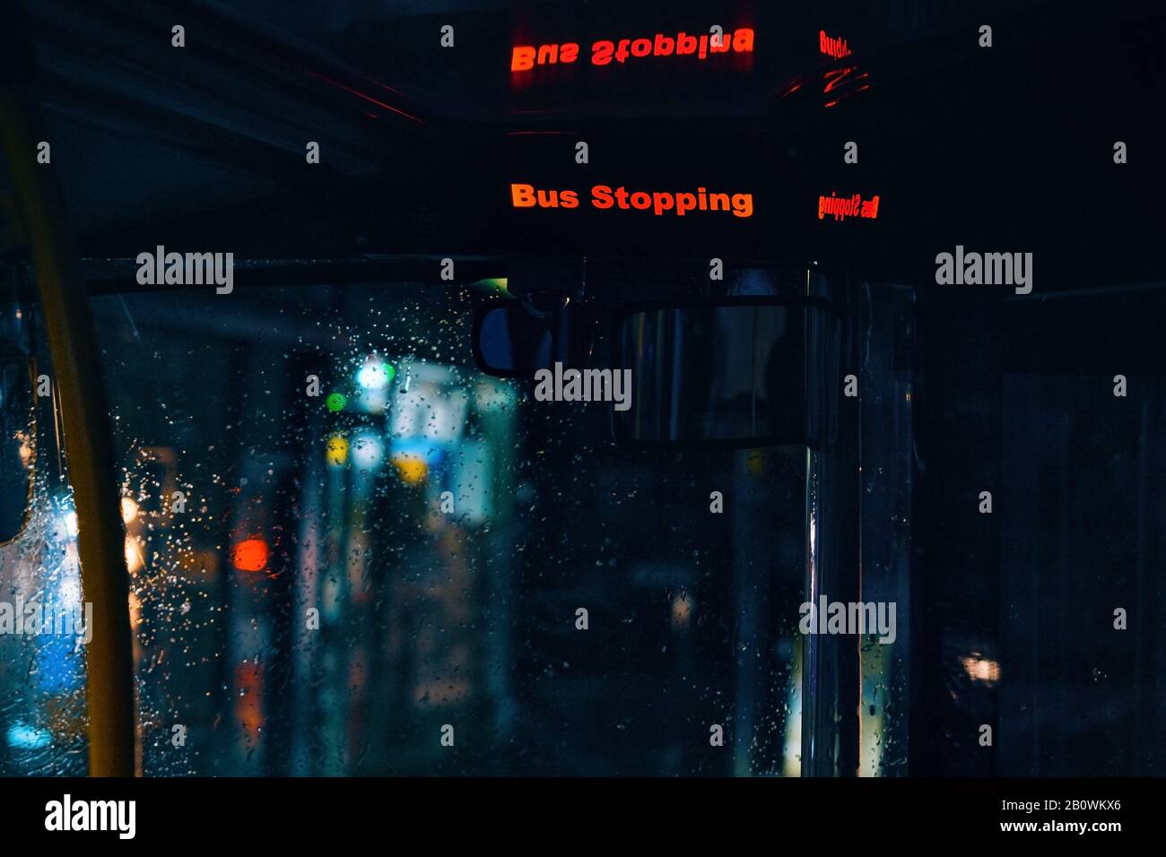 Bright orange Bus Stopping sign in night public transport, blurred ...