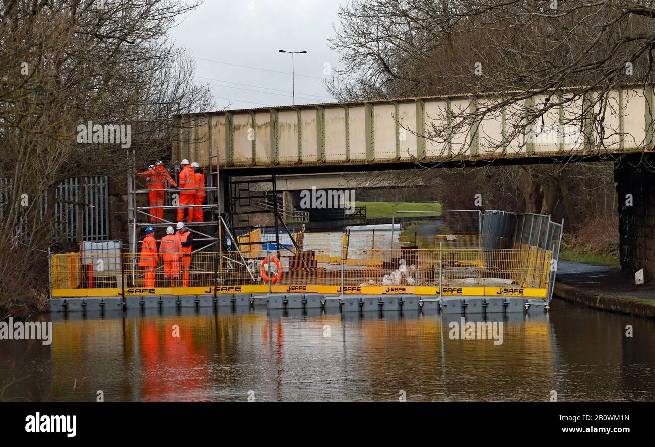 Engineers working from a floating pontoon on the Leeds and Liverpool ...