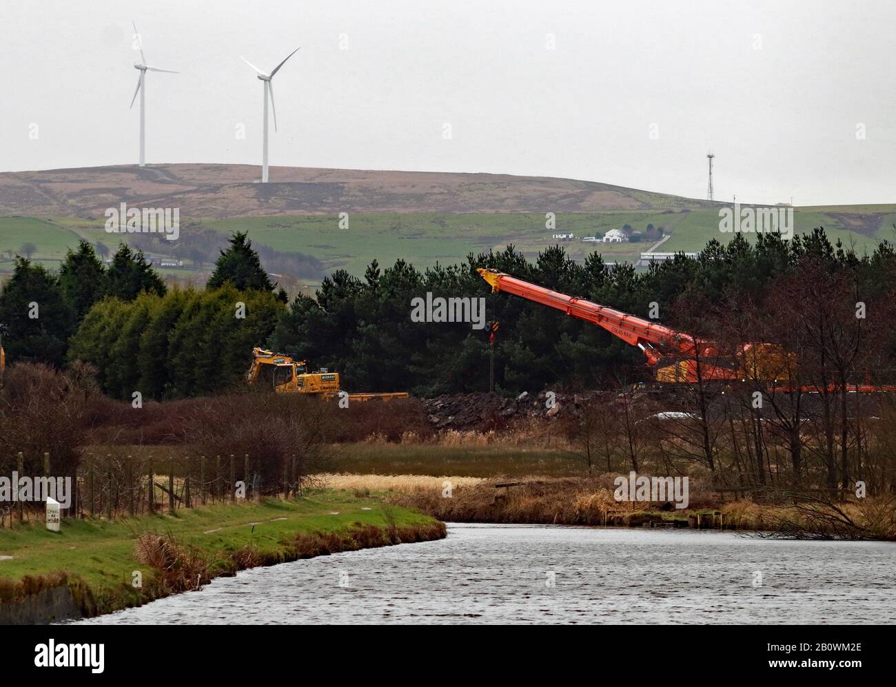Colas crane on the railway over looked by the wind turbines next to the ...