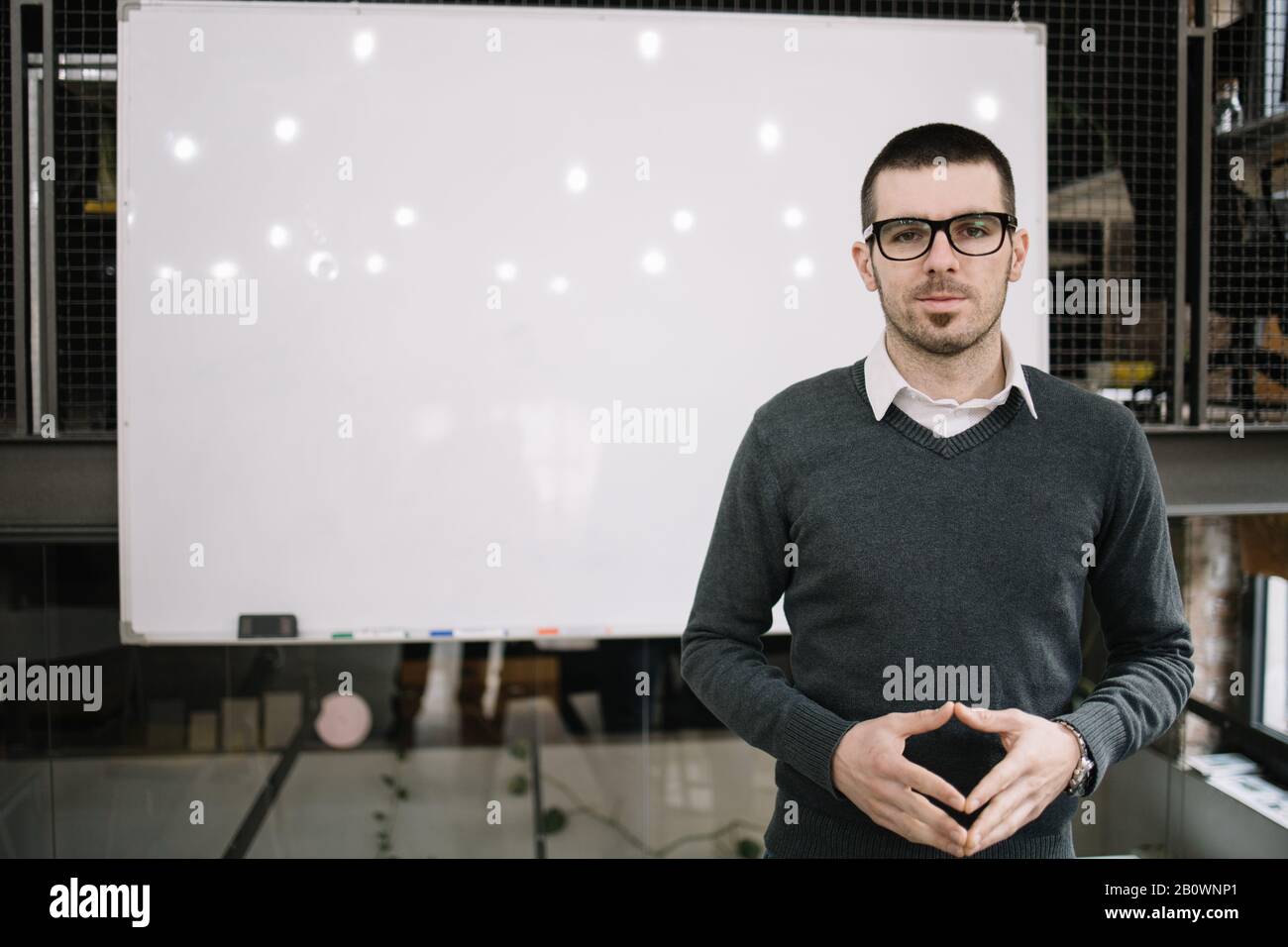 Presenter standing in front of a whiteboard. Bearded business coach ...